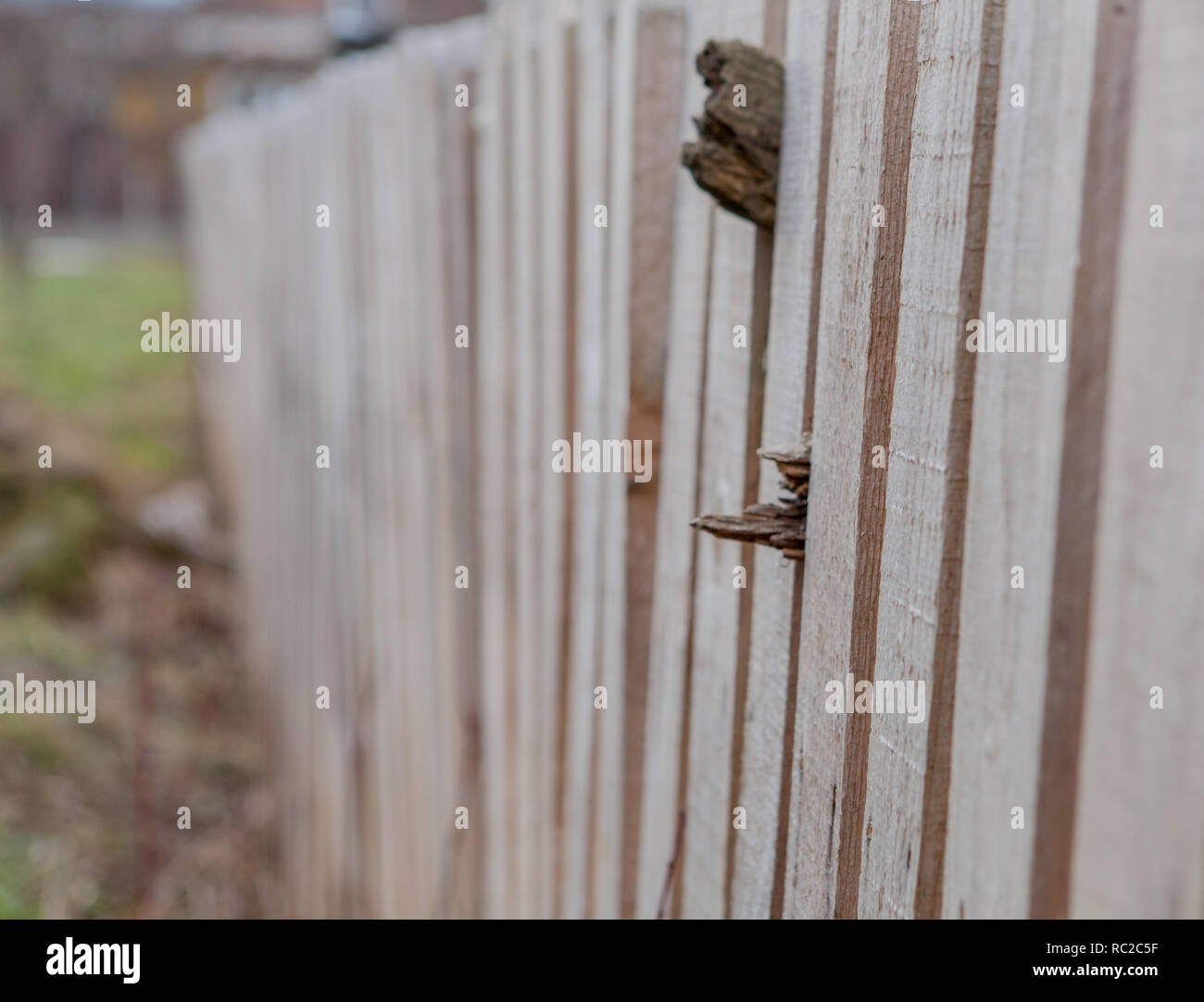 Wooden fence background. Stack of new wooden studs at the lumber yard ...