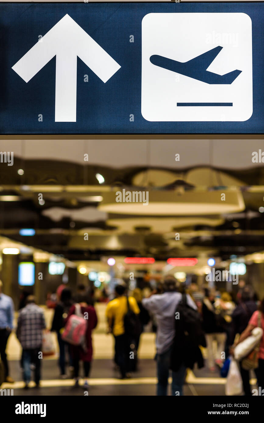 Departures terminal sign inside airport, People and travellers walking ...