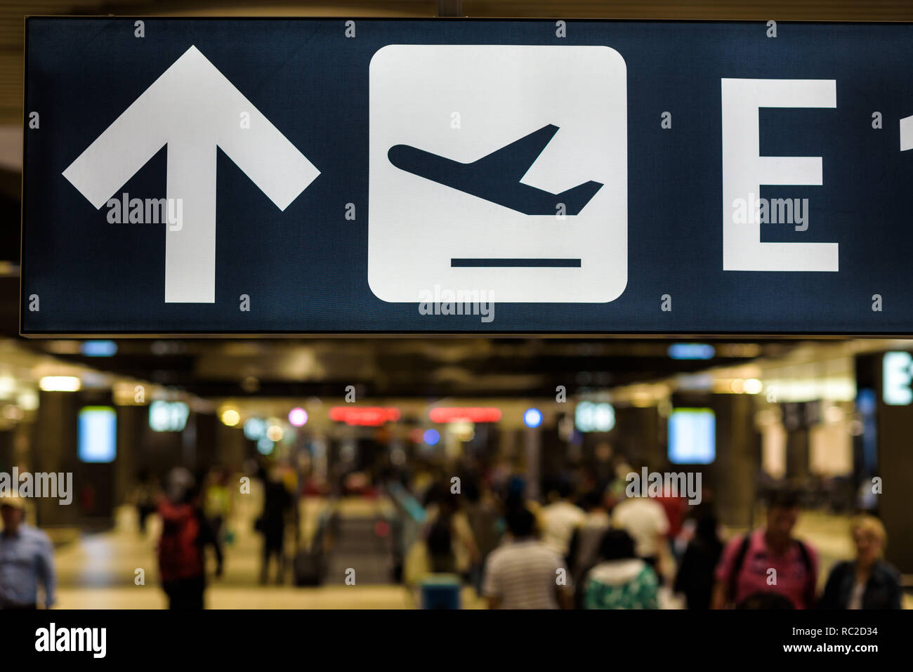 Departures terminal sign inside airport, People and travellers walking ...