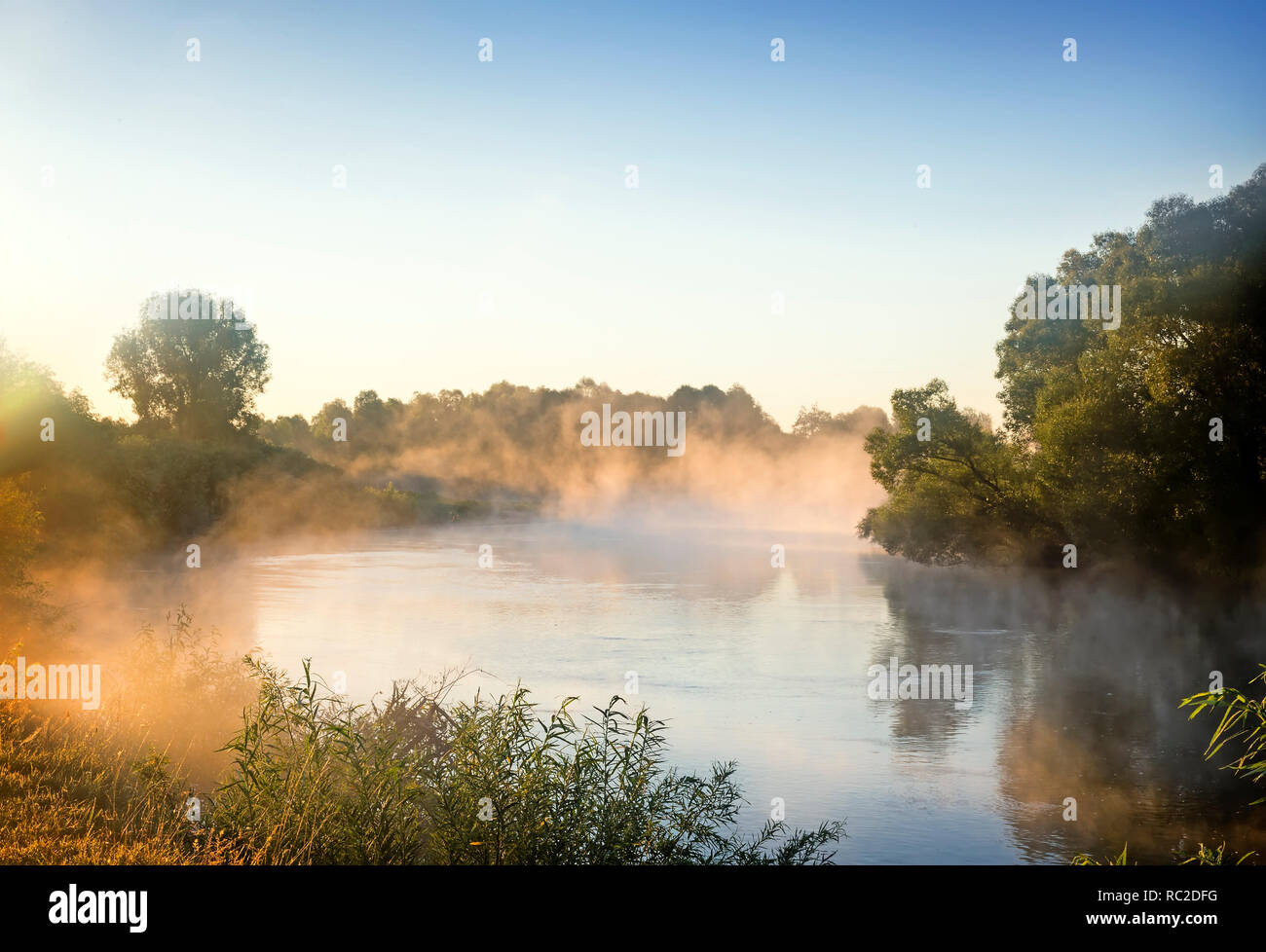 Beautiful calm river with the mist over the surface of the water at ...