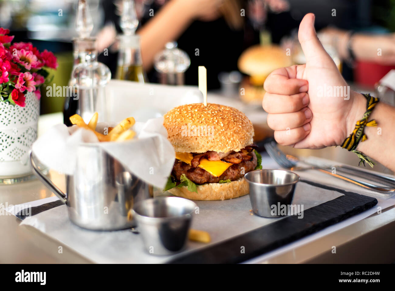 Cheeseburger with french fries served in a restaurant Stock Photo - Alamy