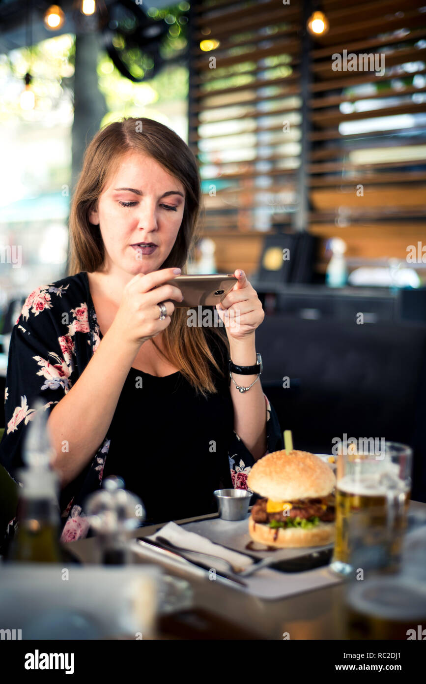 Woman taking photo plate of food hi-res stock photography and images ...