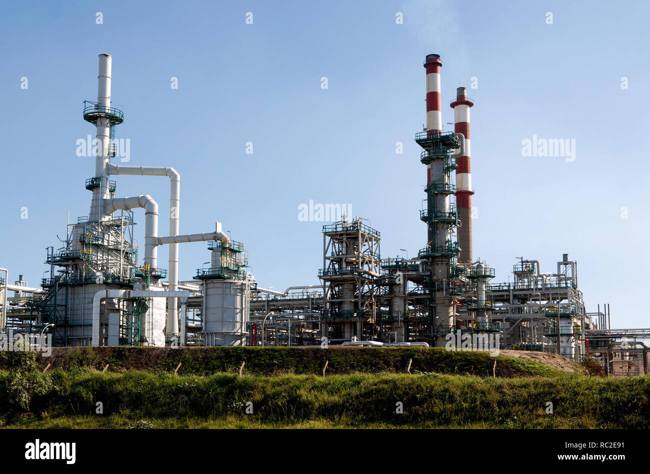 Part of a big oil refinery against blue sky showing some new equipment ...
