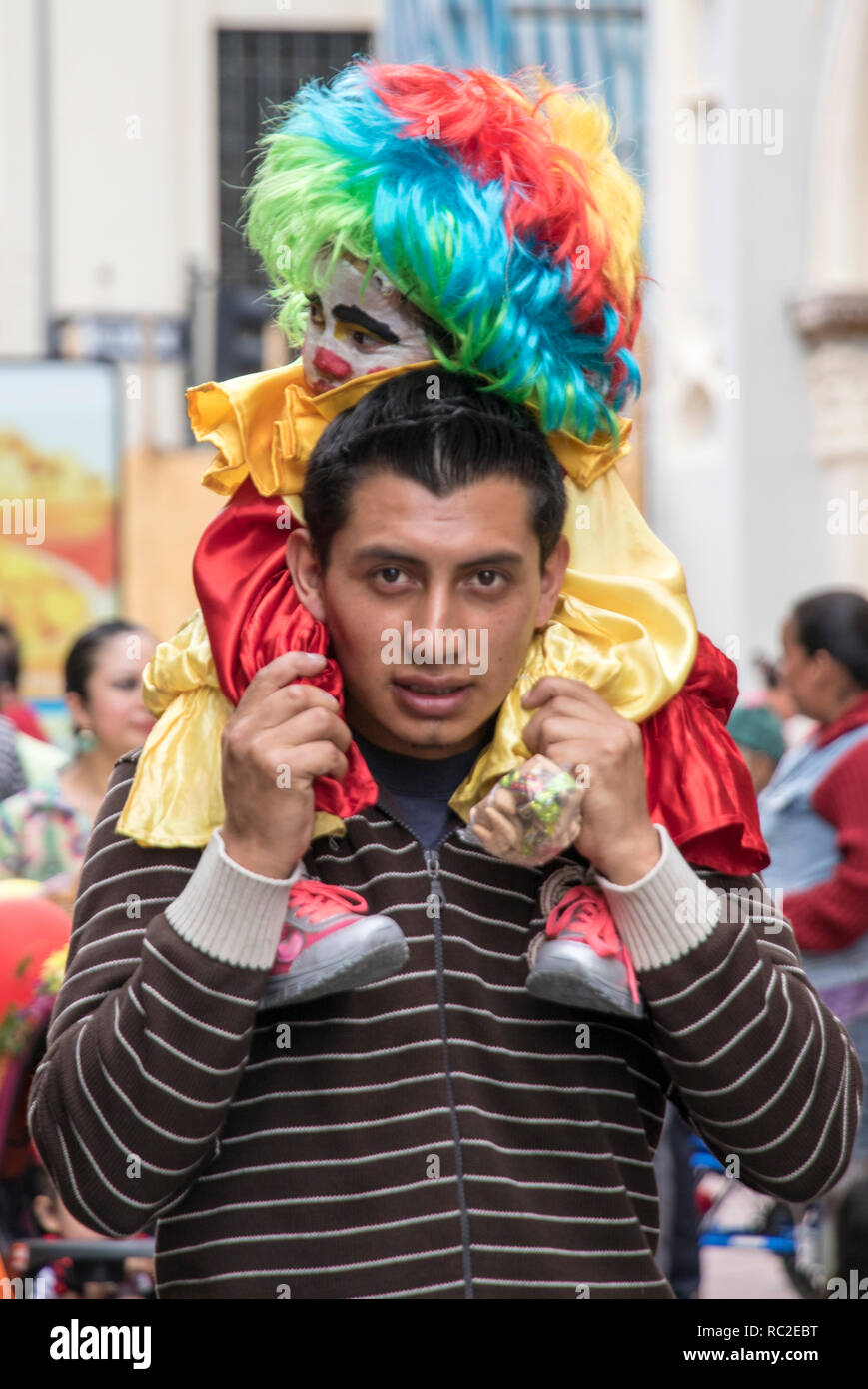 Cuenca, Ecuador / December 24, 2015 - Young father holds his son on his ...