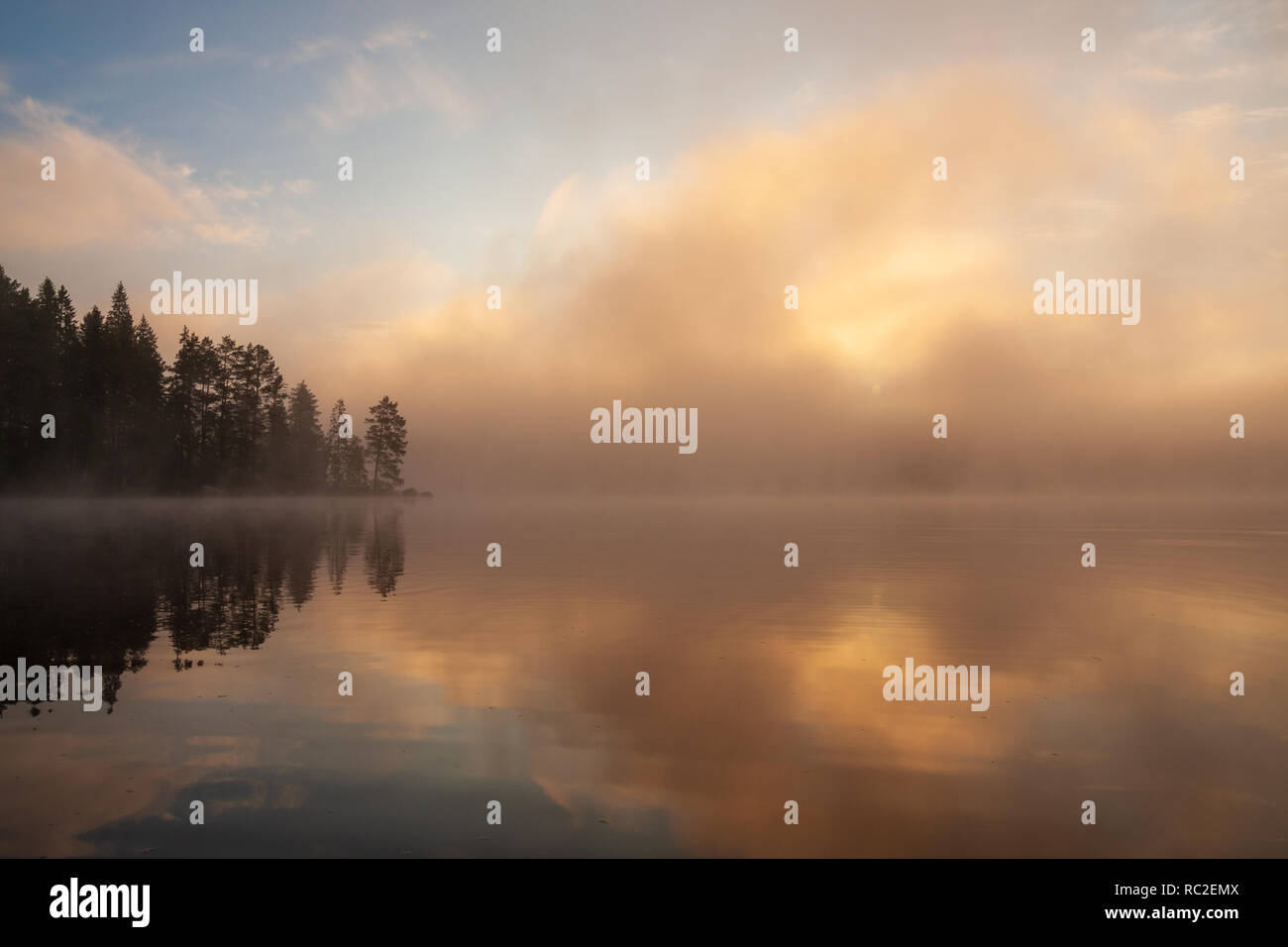 Fog rising from lake at sunrise waterscape Stock Photo - Alamy