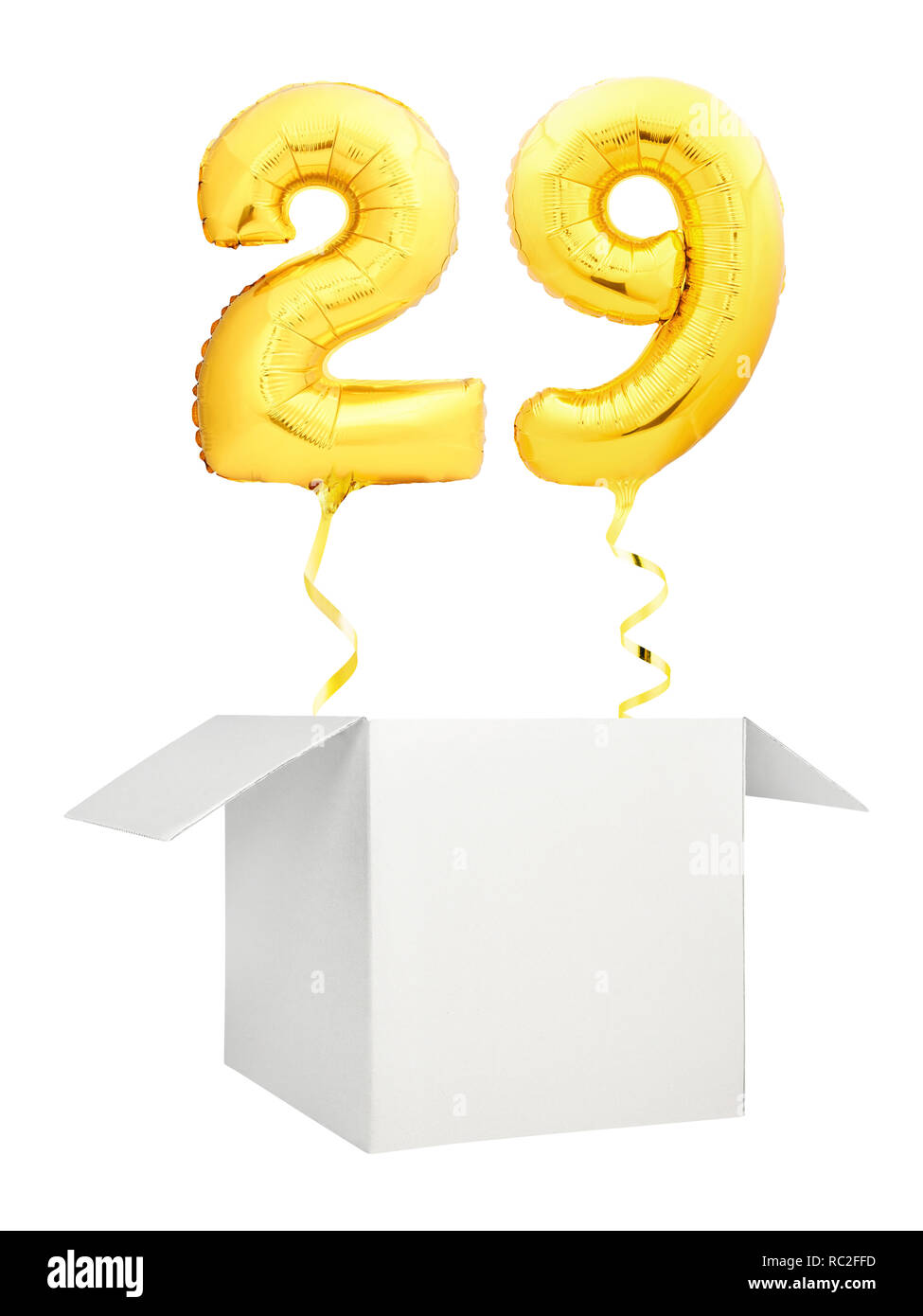 Golden number twenty nine balloon flying out of blank white box ...