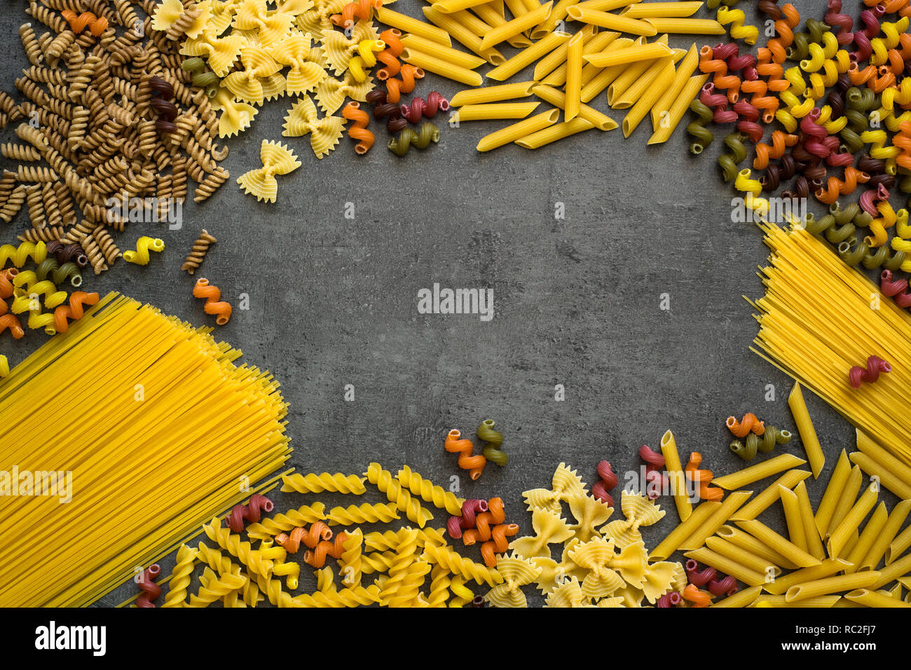 Various types of pasta - spaghetti, penne, fusilli, colored vege Stock ...