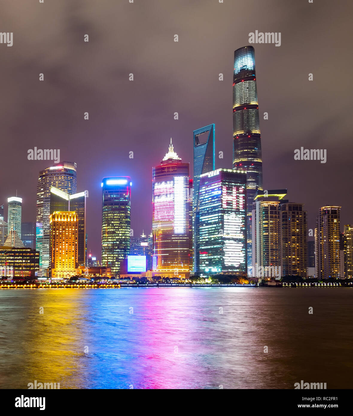 Illuminated Shanghai city skyline at night, with colorful lights ...