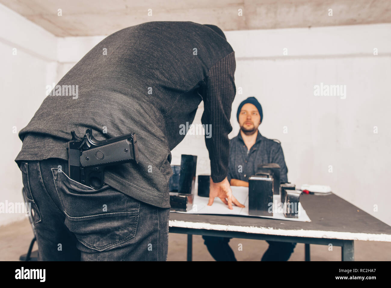 Two young thiefs are sitting in a room and planning a heist Stock Photo ...