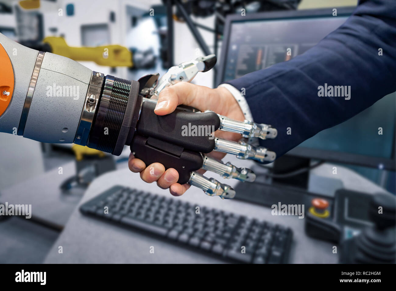 Hand of a businessman shaking hands with a Android robot. The concept ...