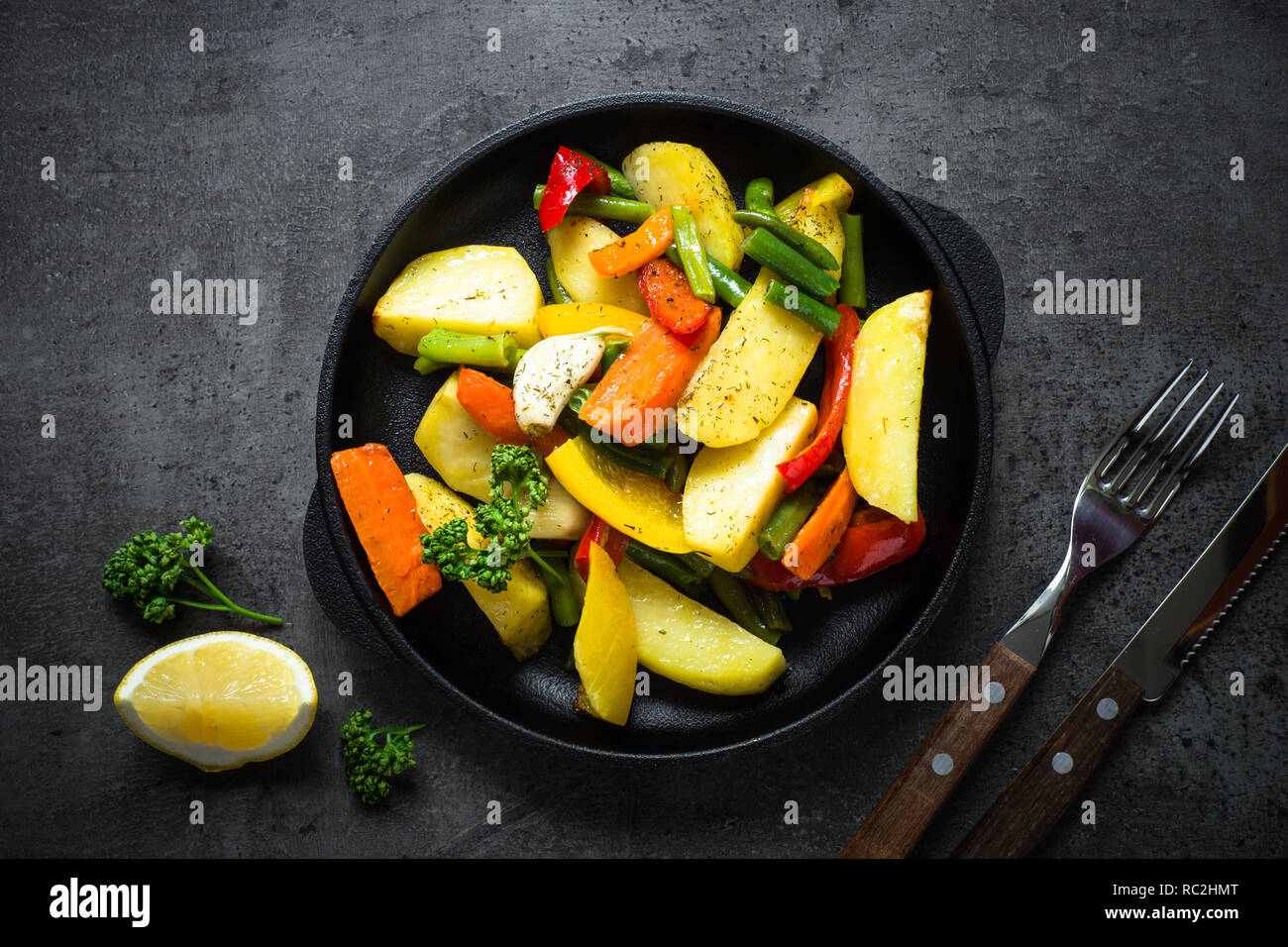 Roasted vegetables in black iron plate Stock Photo - Alamy