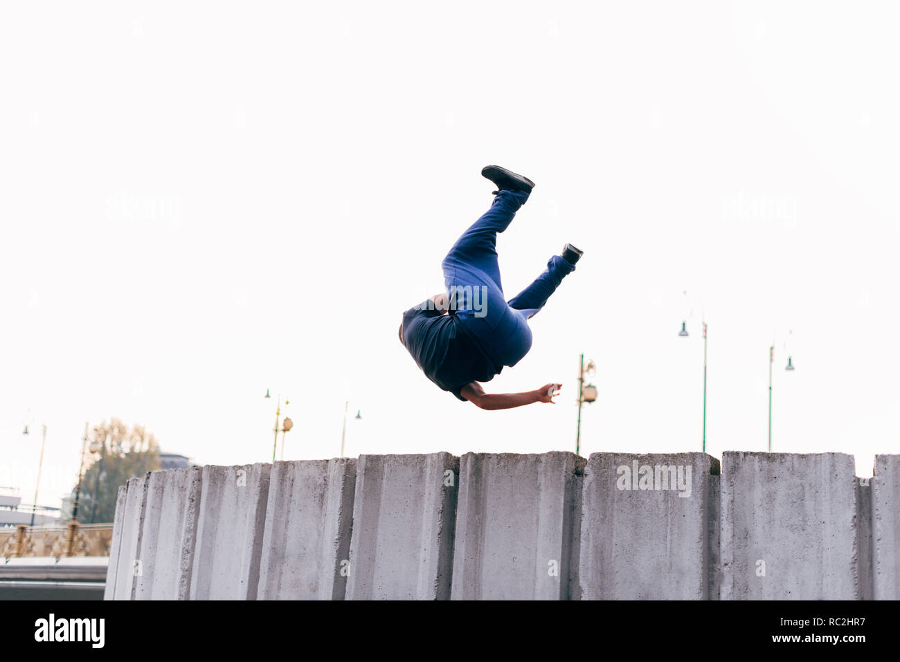 Caucasian man trains parkour while jumping over a high top Stock Photo ...