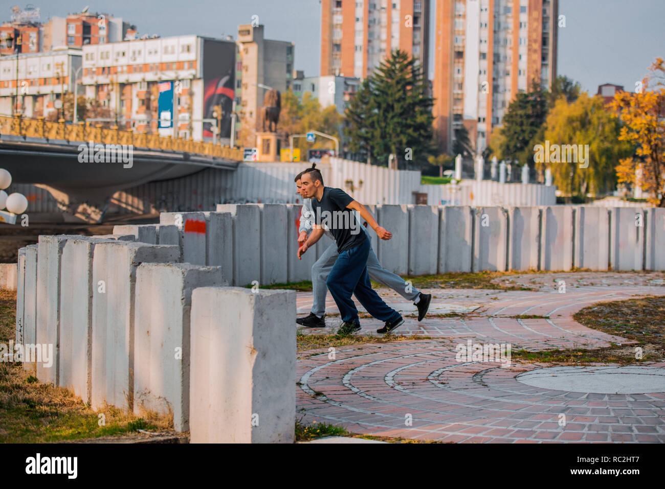 Parkour team running together through the obstacles Stock Photo - Alamy