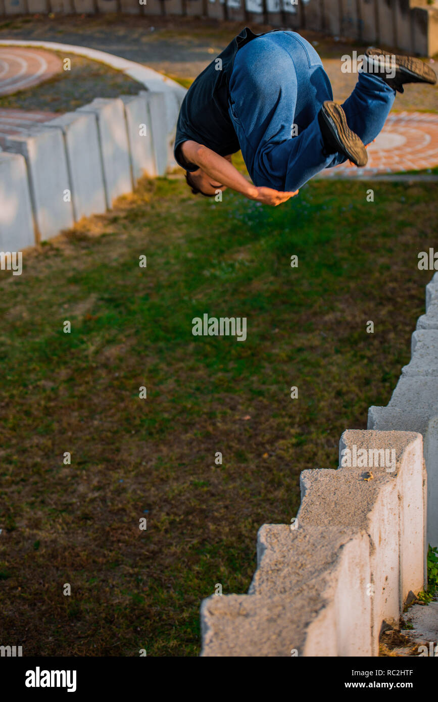 Sportsman jumping over obstacles while exercising parkour Stock Photo ...
