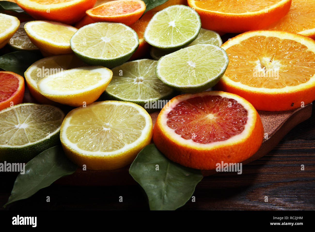 Citrus fruits with orange, lemon, grapefruit and lime on brown ...