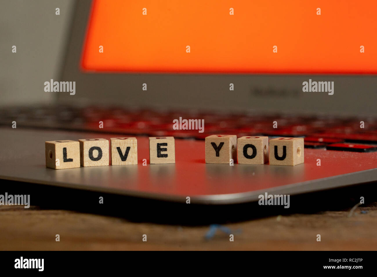 Conceptual image of text Love you in wood blocks on computer with mood ...