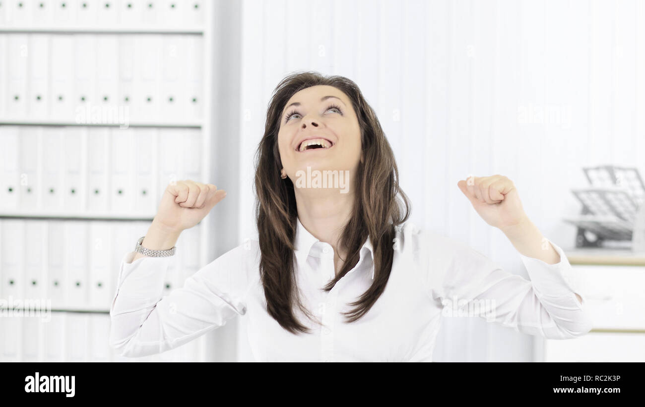 Portrait of a happy young business woman in the office, hands up Stock ...