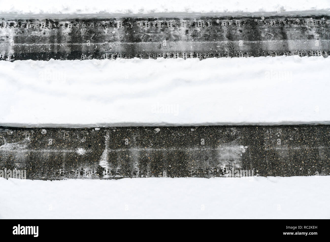 cleared path through deep snow on an asphalt road after a heavy ...