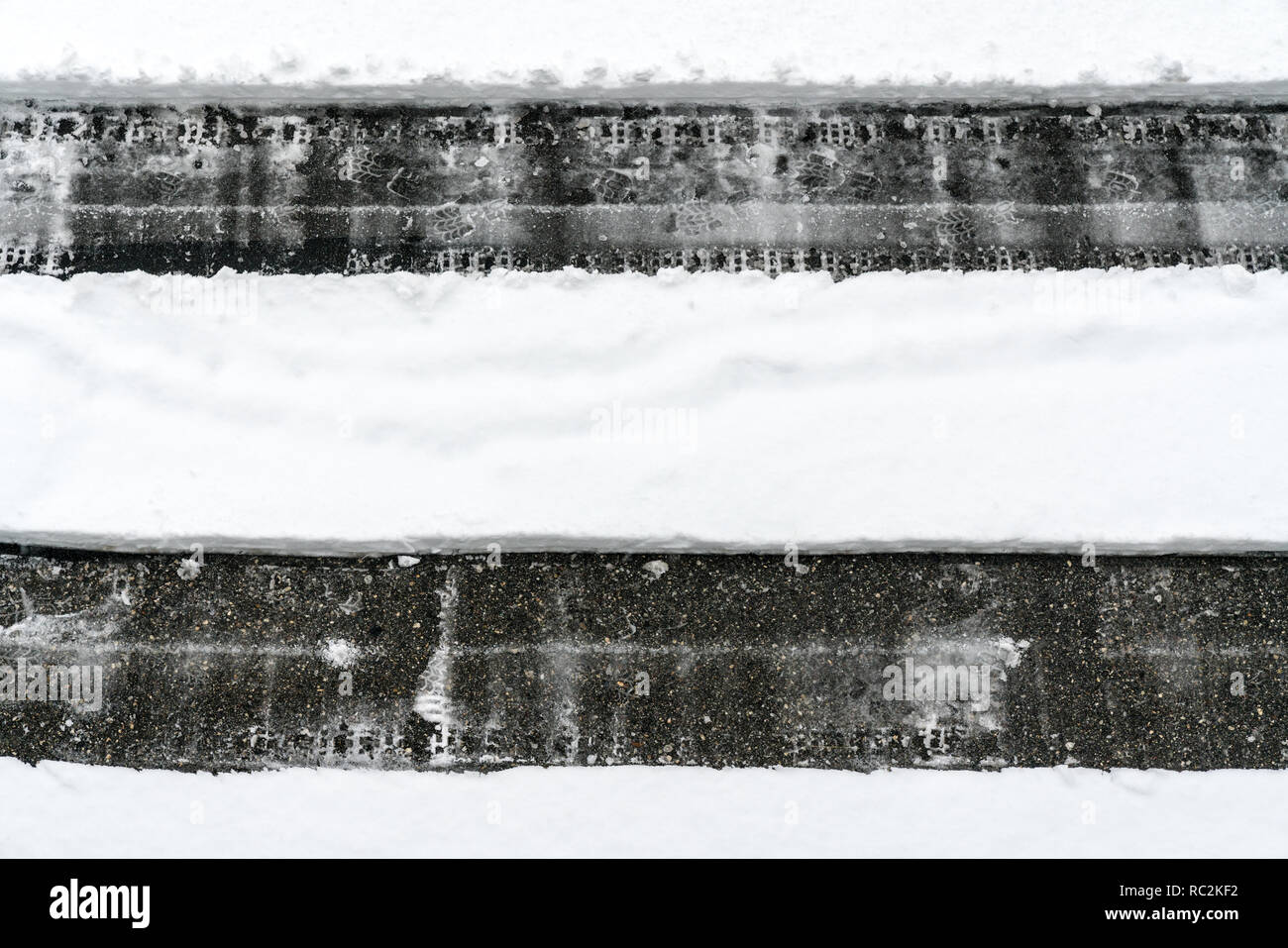 cleared path through deep snow on an asphalt road after a heavy ...