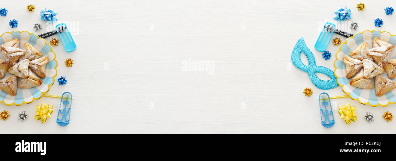 Purim celebration concept (jewish carnival holiday) over wooden white ...