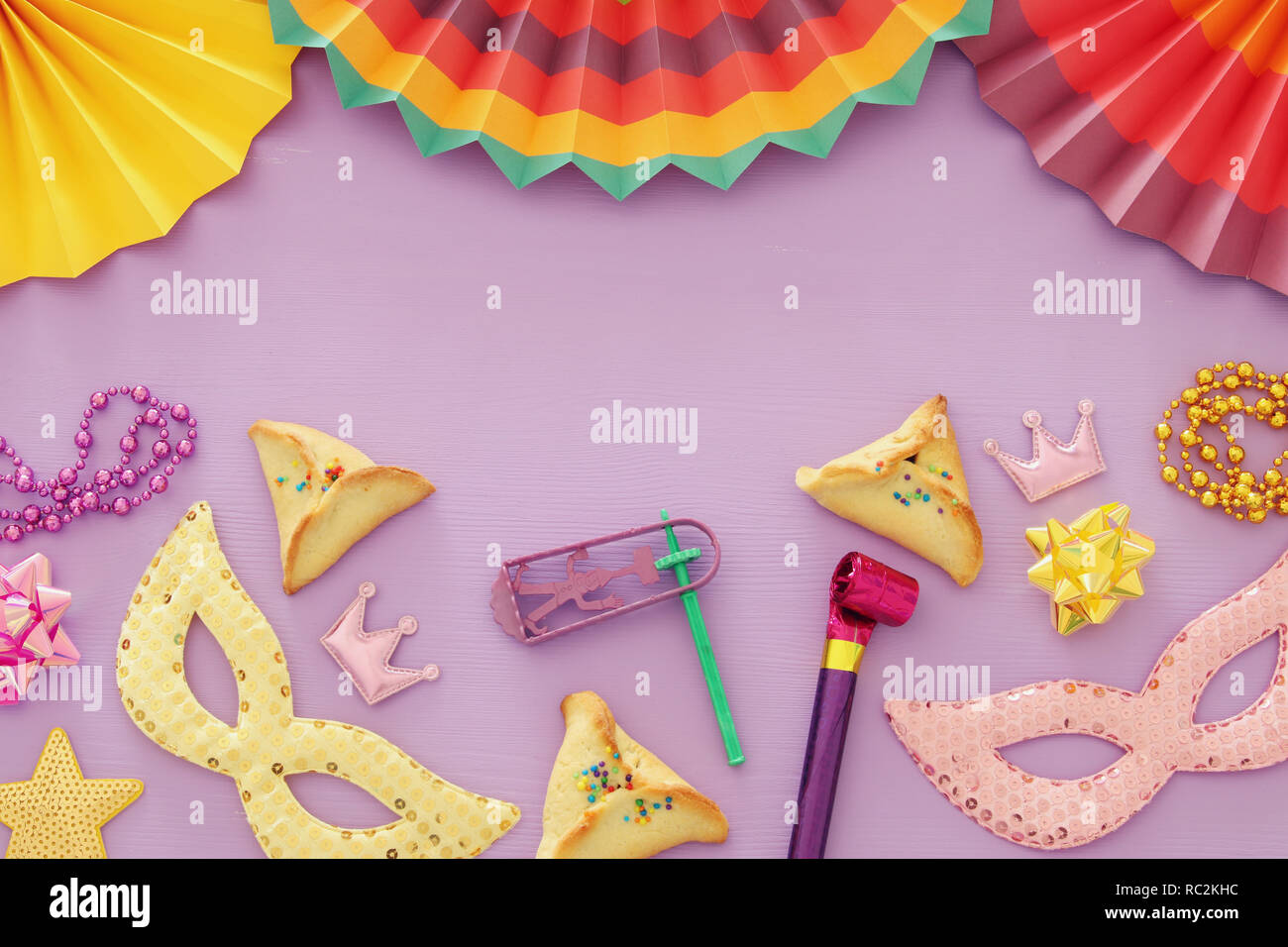 Purim celebration concept (jewish carnival holiday) over wooden pink ...