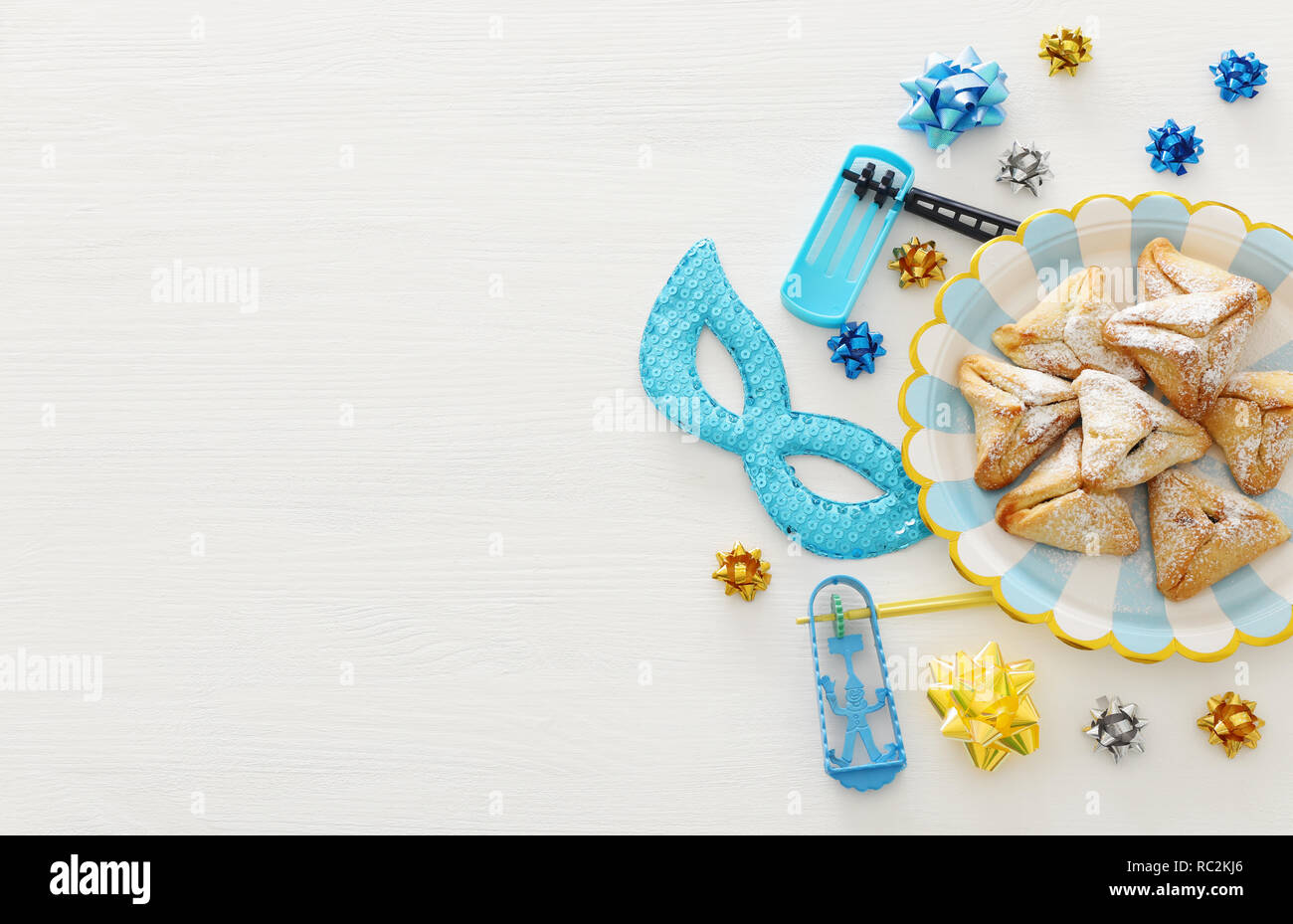 Purim celebration concept (jewish carnival holiday) over wooden white ...