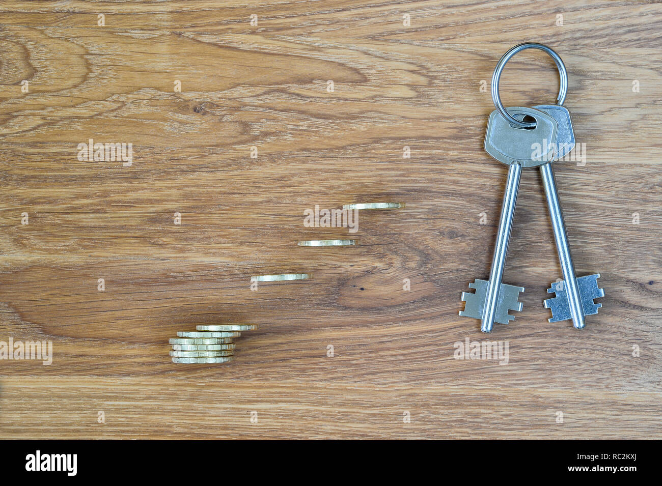 Metal keys of the lock of the new house on a wooden beautiful oak ...