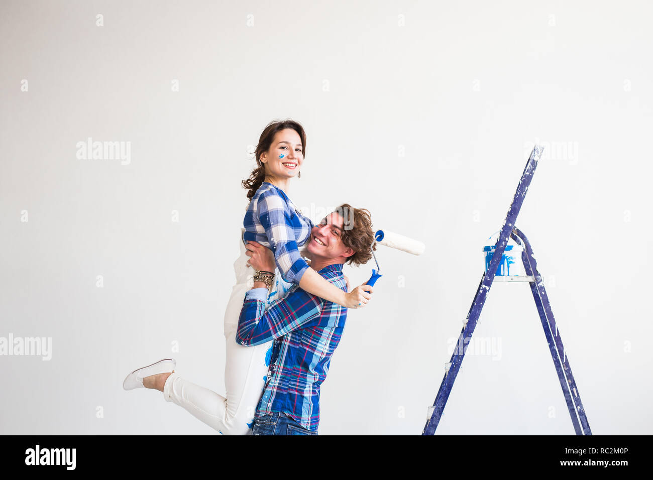 Renovation, redecoration and family concept - Young man holds young ...