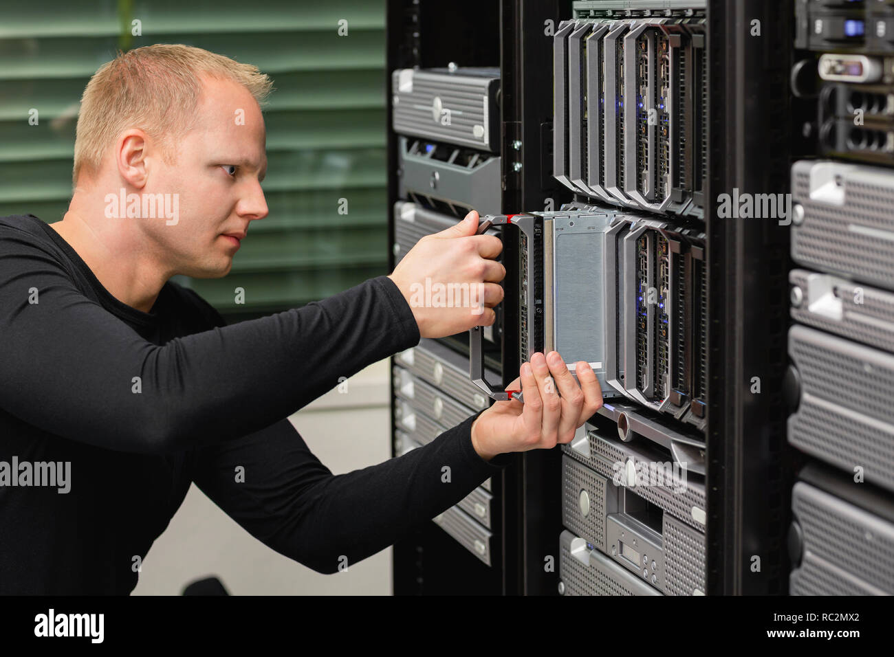 Male Technical Consultant Replacing Blade Server In SAN At Datacenter ...