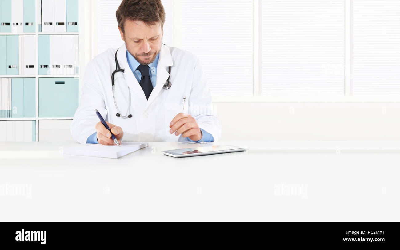 doctor prescribes prescription sitting at the desk medical office ...