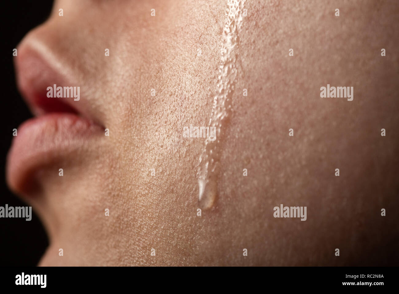 sad woman cries, shot a close up of female cheek with a tear drop Stock ...