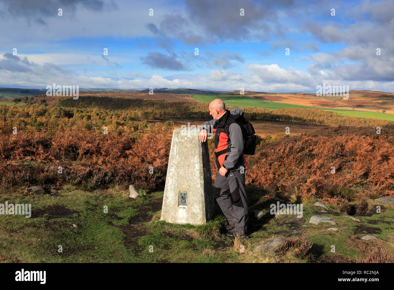 Walker at the OS Trig Point on Birchen Edge, Peak District National ...