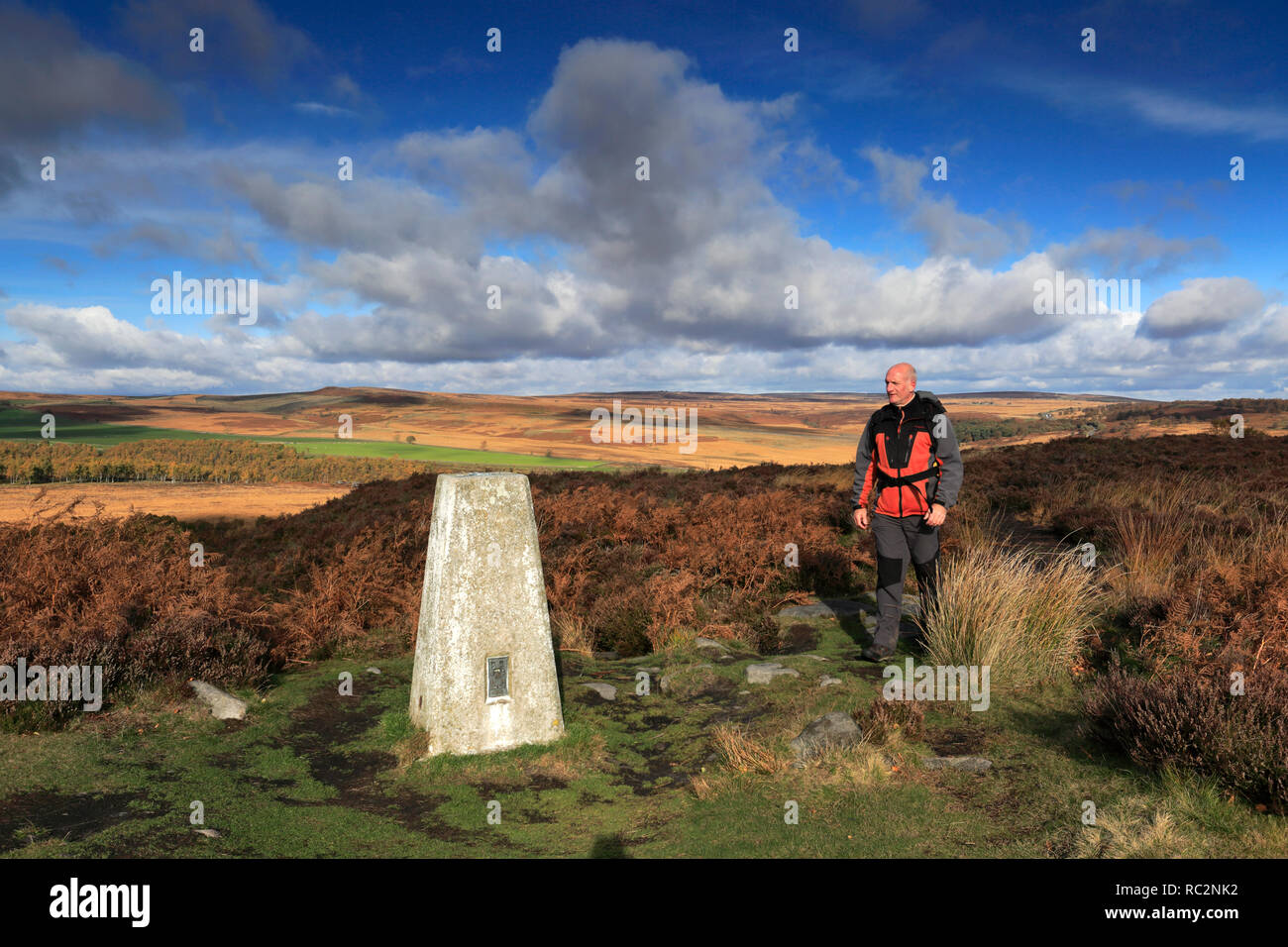 Walker at the OS Trig Point on Birchen Edge, Peak District National ...