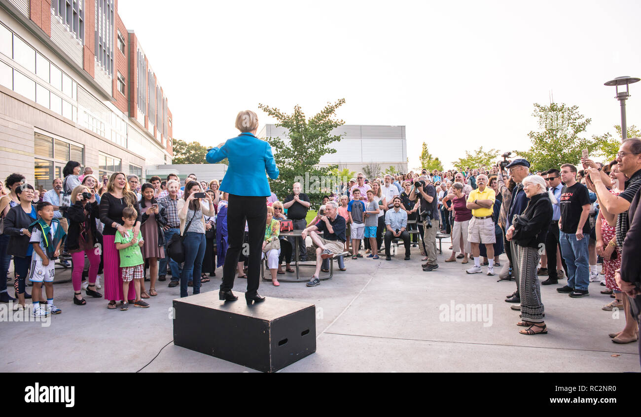 US Senator Elizabeth Warren standing on a podium and speaking to crowd ...