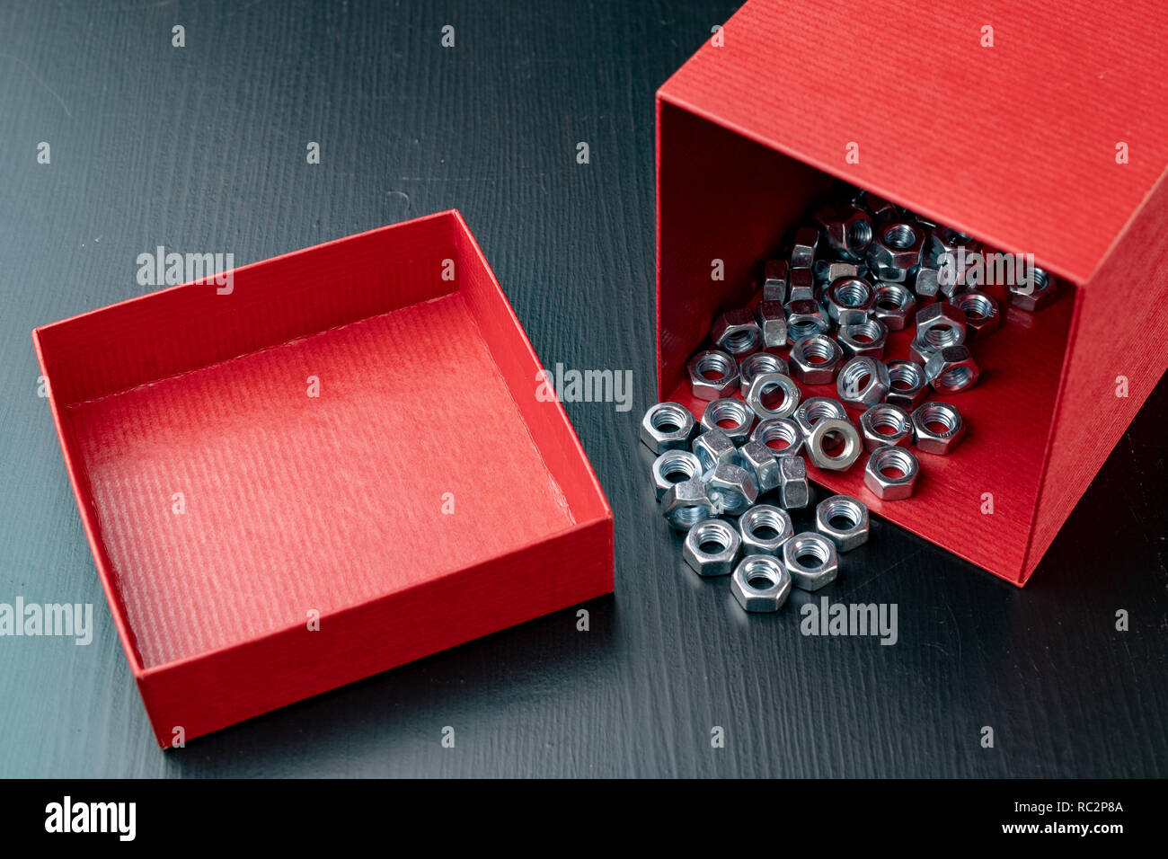 New nickel-plated screws in a red container. Accessories for mechanics ...