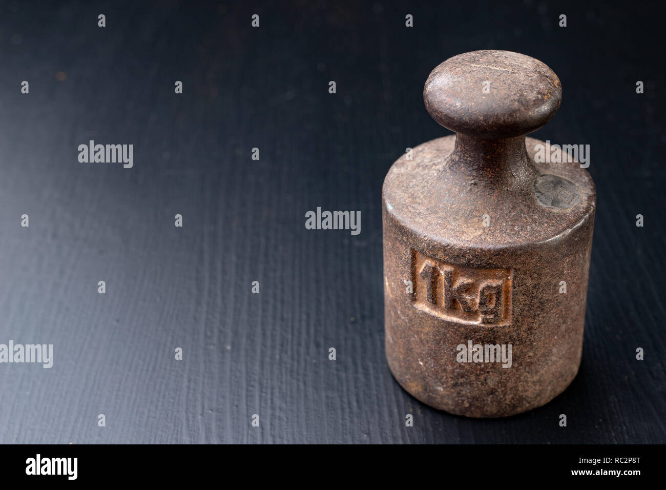 Old rusty weights on a dark table. Accessories for weighing products ...