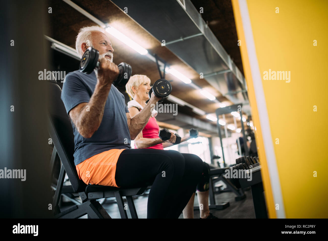 Happy fit mature man in gym working out to stay healthy Stock Photo - Alamy