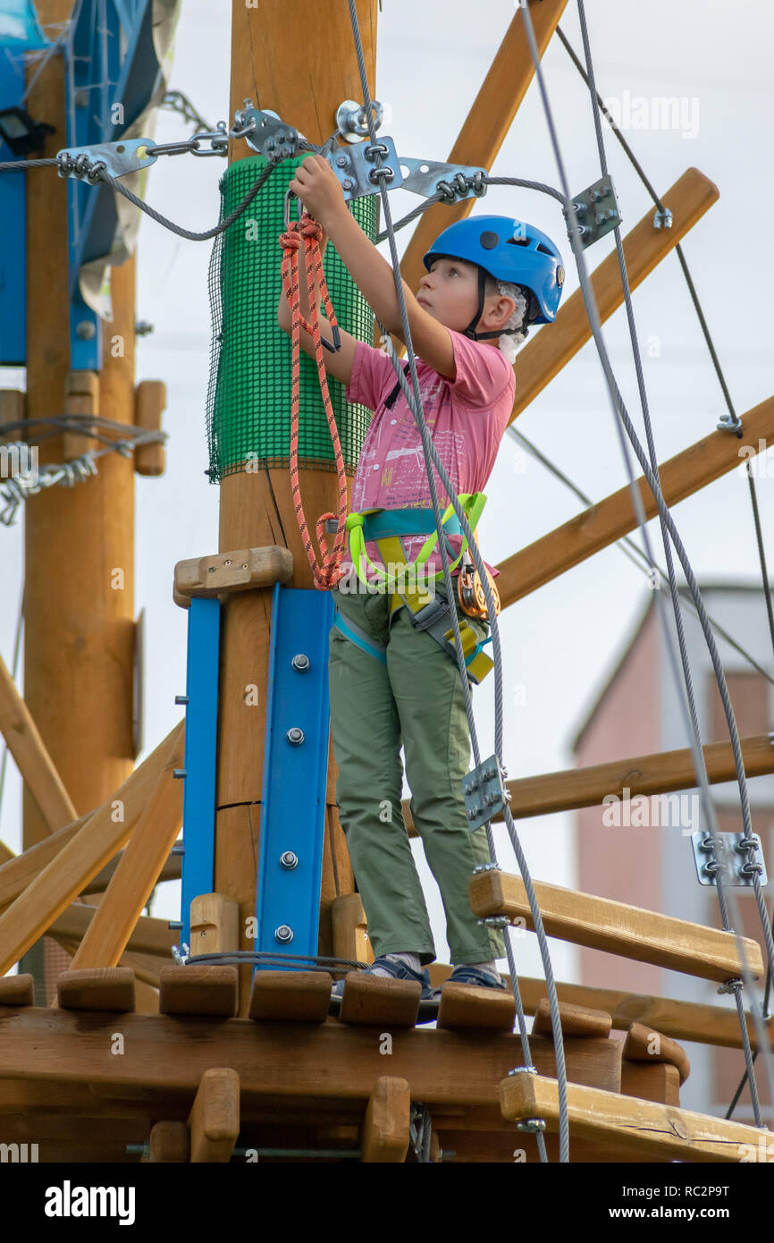 Boy climbing in the rope park in summer Stock Photo - Alamy