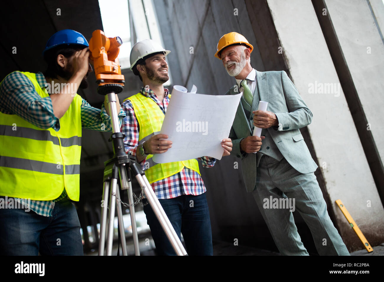 Engineer and construction site manager dealing with blueprints and ...