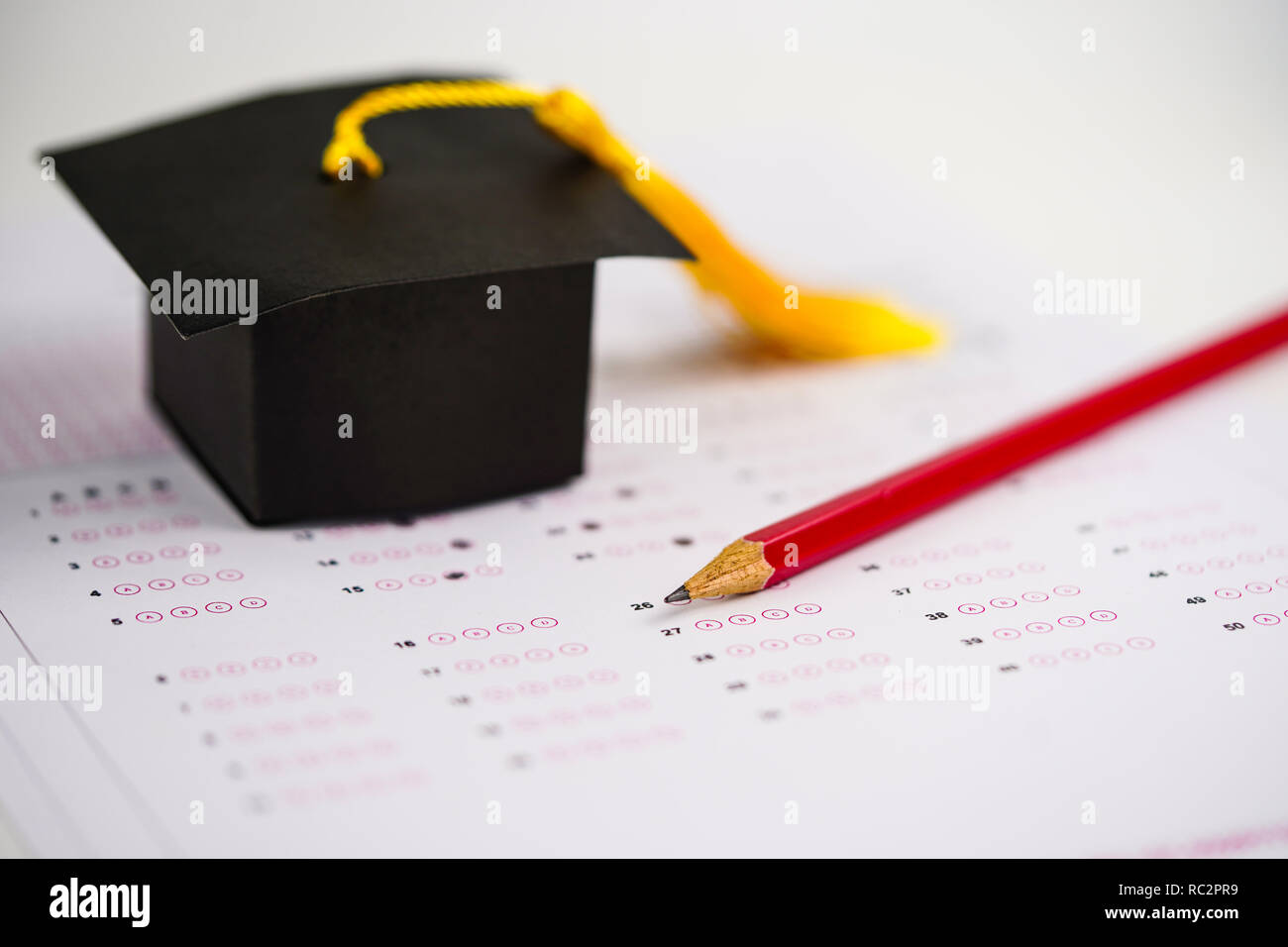 Graduation gap hat and pencil on answer sheet background : Education ...