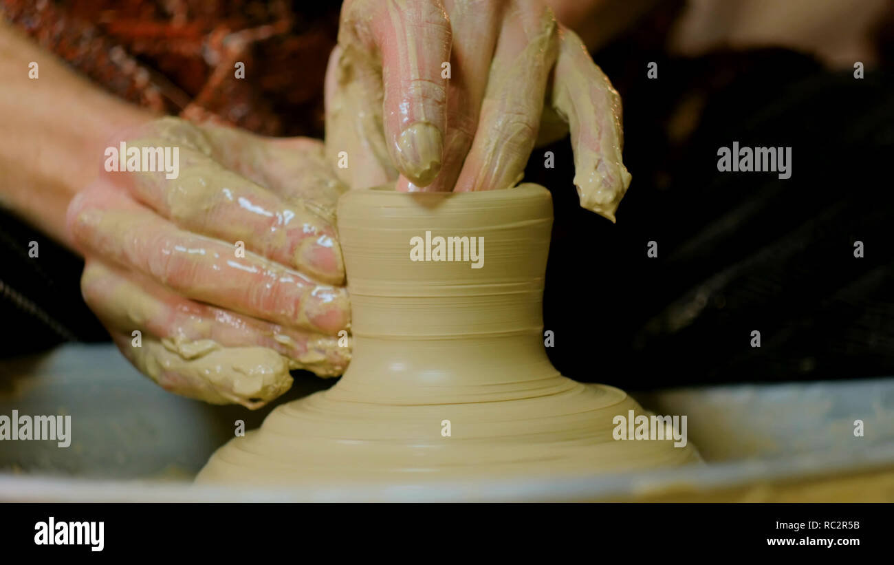 Professional male potter making mug in pottery workshop, studio ...