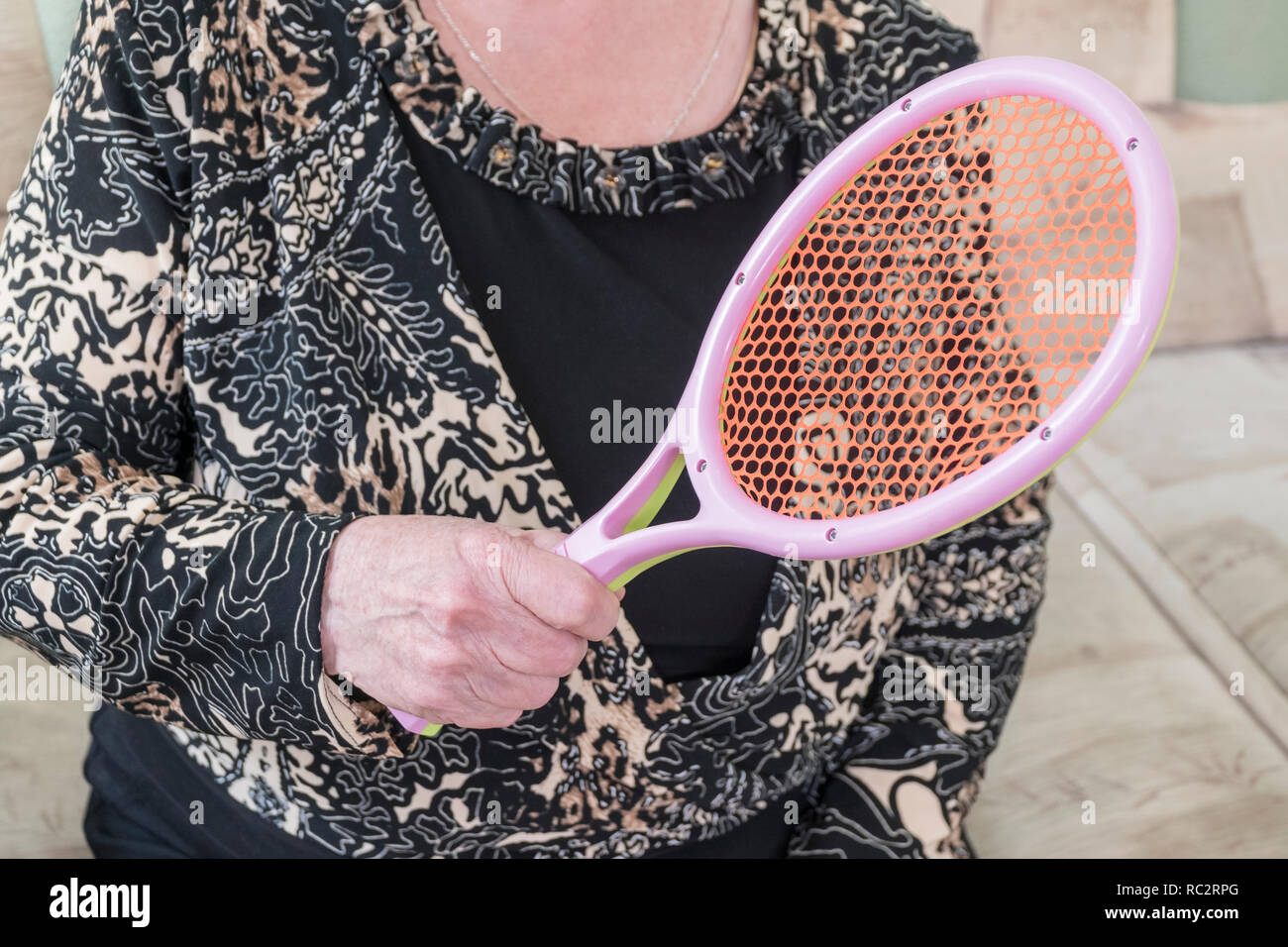 Old woman with racket Stock Photo - Alamy