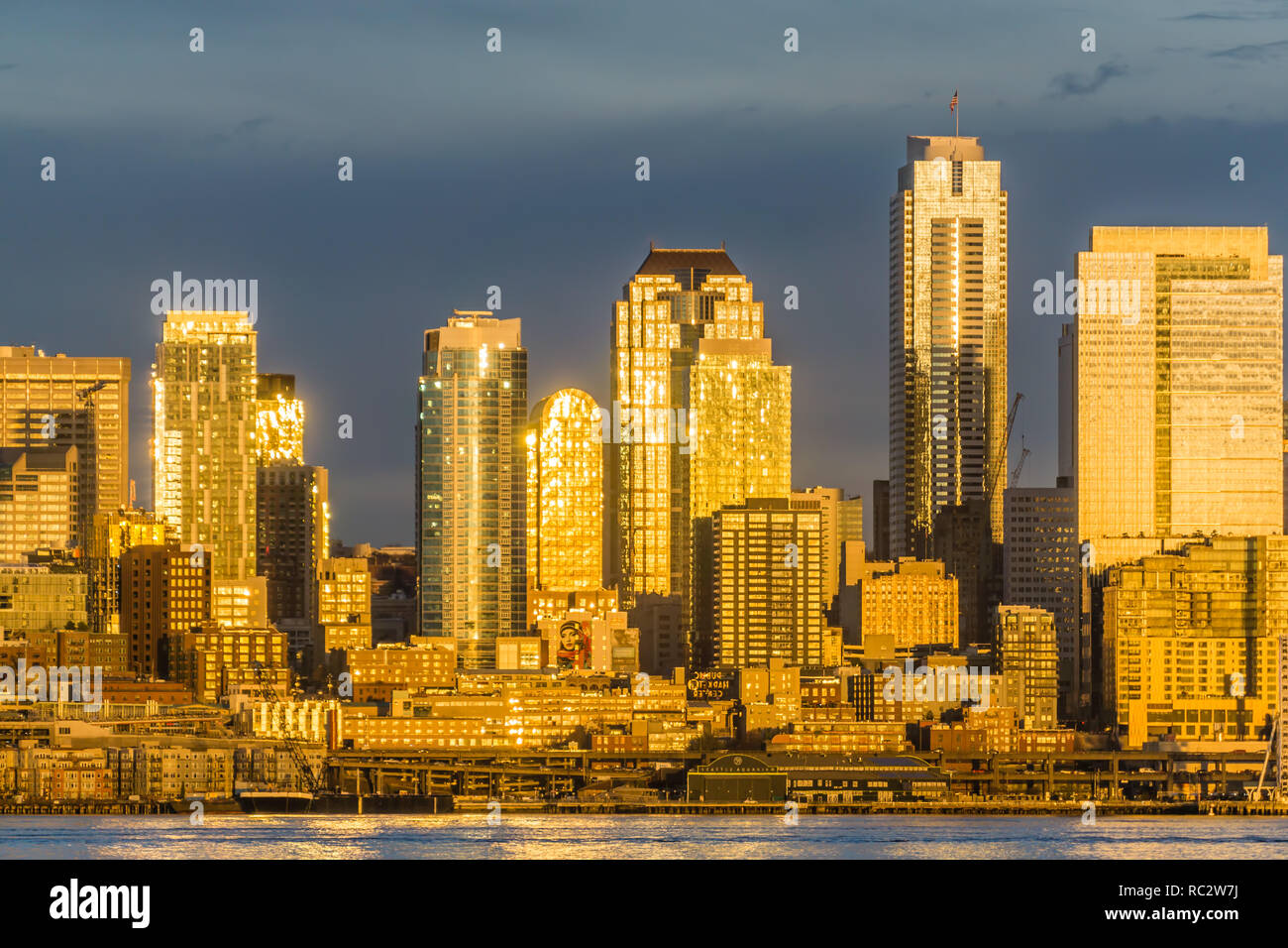 The setting sun is reflected from the skyscrapers in the Seattle ...