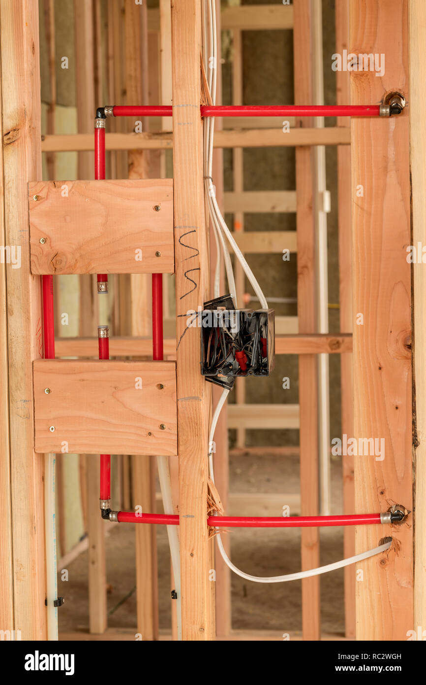 Home under construction with electrical and plumbing set between wooden ...