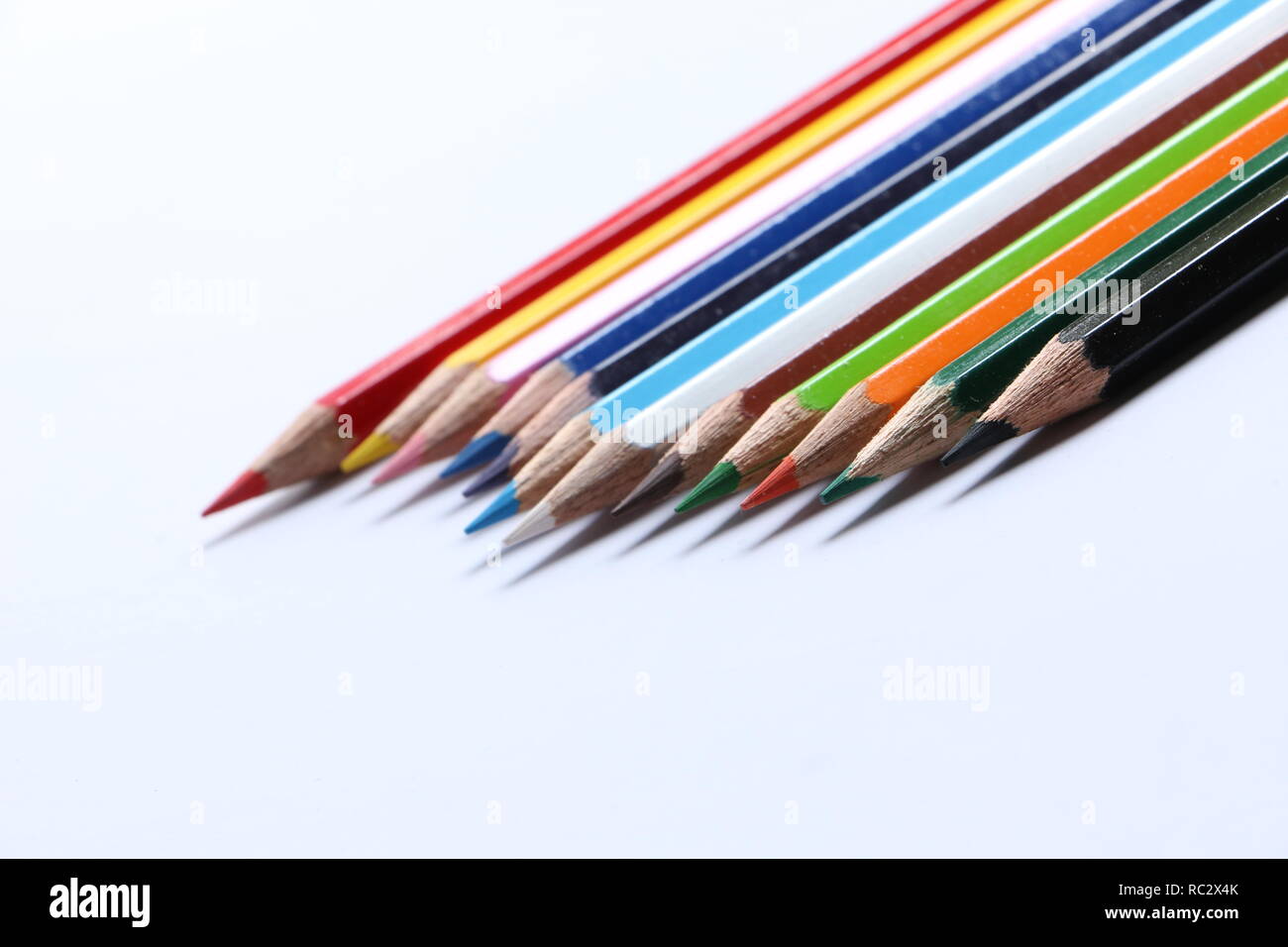 Close up of multi colored pencils in a row Stock Photo - Alamy