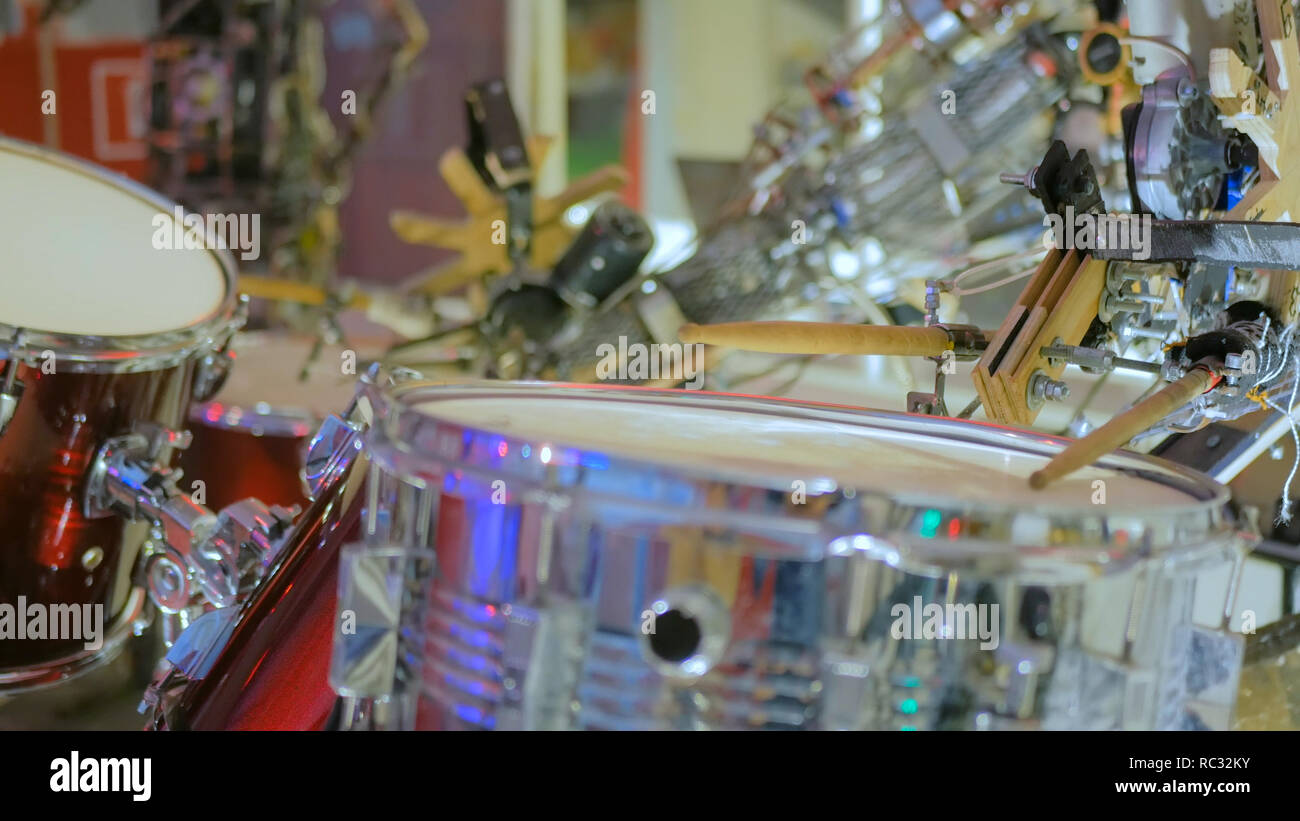 Vintage robot playing drums. Close up shot of robot hand with drumstick ...