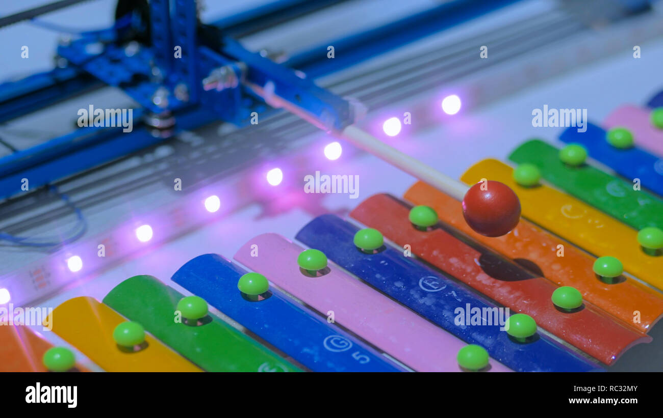 Robot playing on colorful xylophone at technology exhibition. Future ...