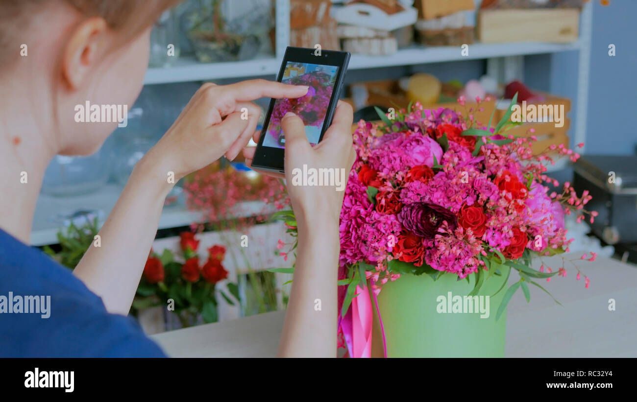Professional floral artist, florist taking photo of her beautiful ...