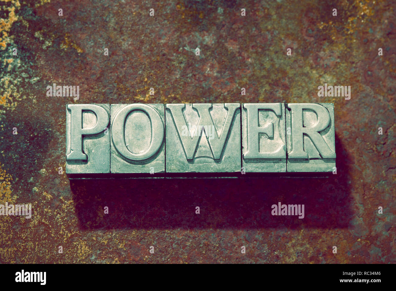 power word made from metallic letterpress on rusty metallic background ...