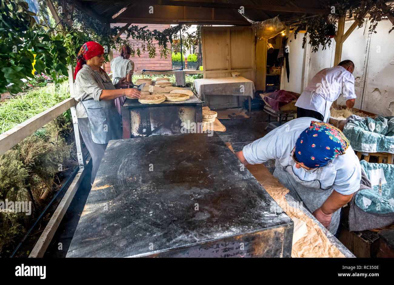 Baker making the traditional Madeira bread, Bolo Do Calco Stock Photo ...